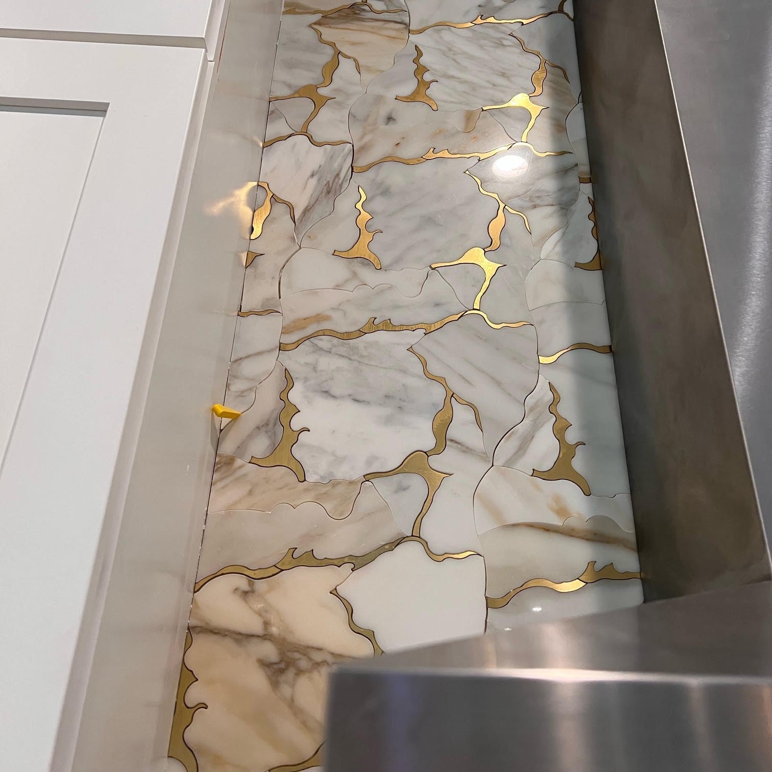 Calacatta Gold Marble and Brass Waterjet Mosaic Tile in Geode