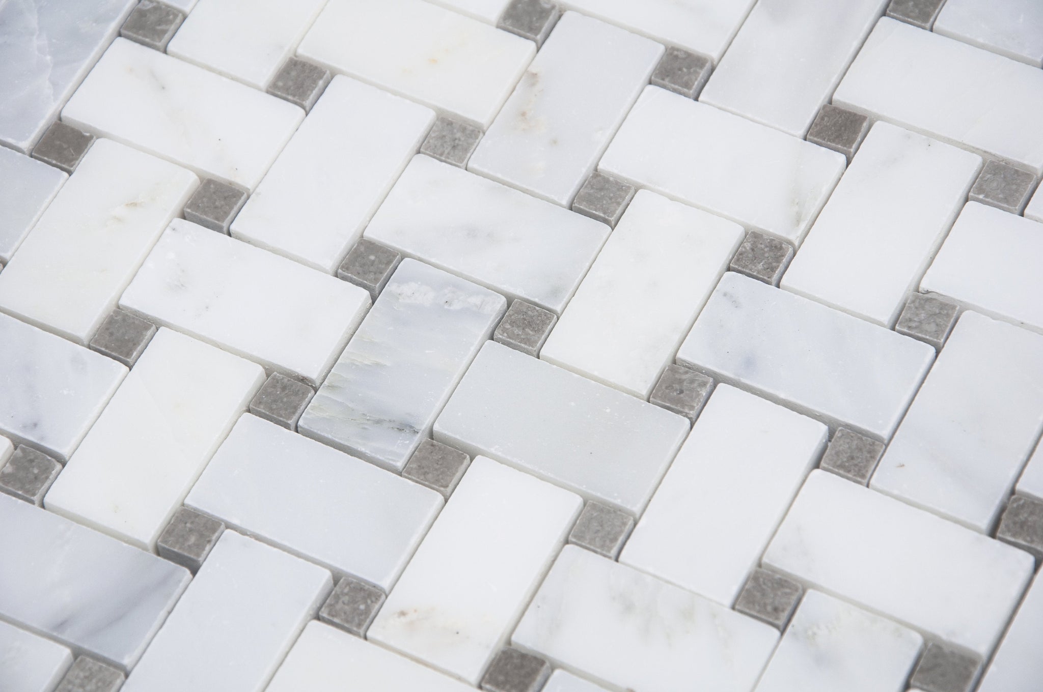 Carrara Venato marble in a classic basketweave mosaic pattern accented by Lady Gray marble ...
